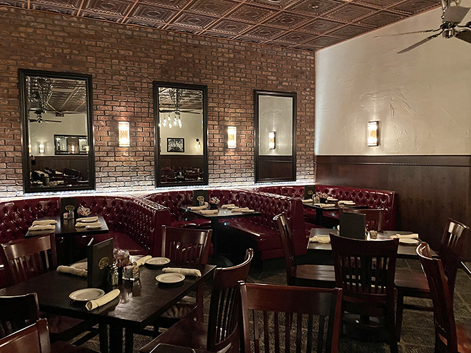Red leather booths against exposed brick walls&mdash;where date nights become anniversaries and business dinners become partnerships.