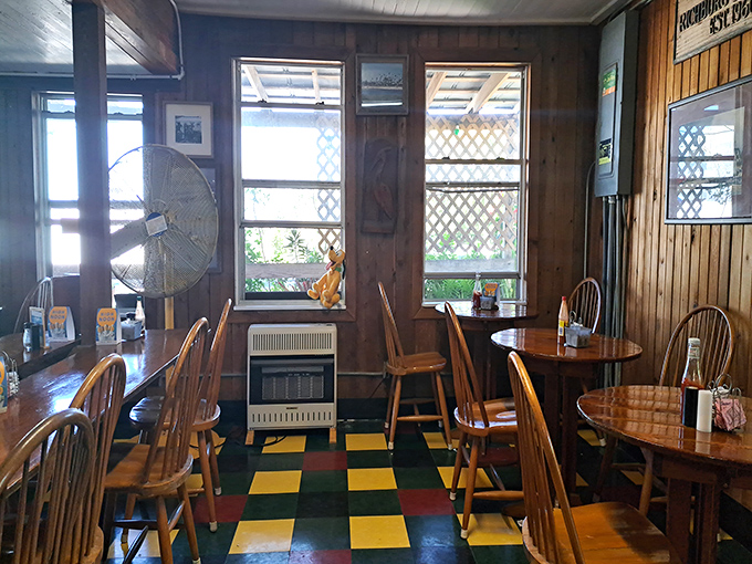 Sunlight streams through latticed windows onto the checkerboard floor, creating the perfect backdrop for morning conversations and coffee refills.
