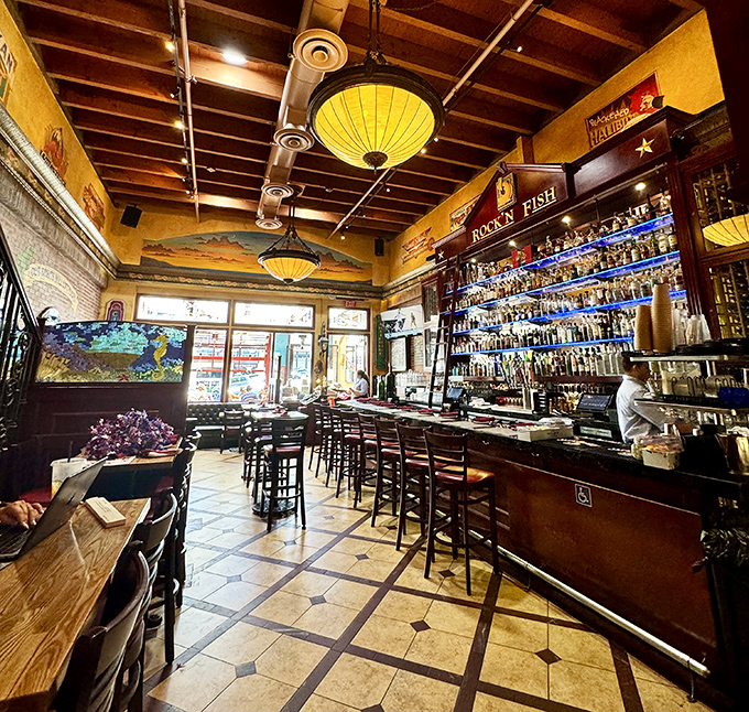 The bar area glows with amber lighting and promises of good times. Those pendant lights aren't just illuminating the room&mdash;they're setting the mood.