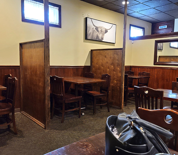 Cozy wooden booths create intimate dining spaces where memories are made between bites of perfectly cooked ribeye.