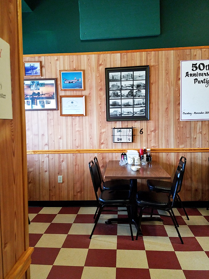 Wood-paneled walls and checkerboard floors tell stories of countless meals shared, deals made, and friendships forged over plates of comfort.