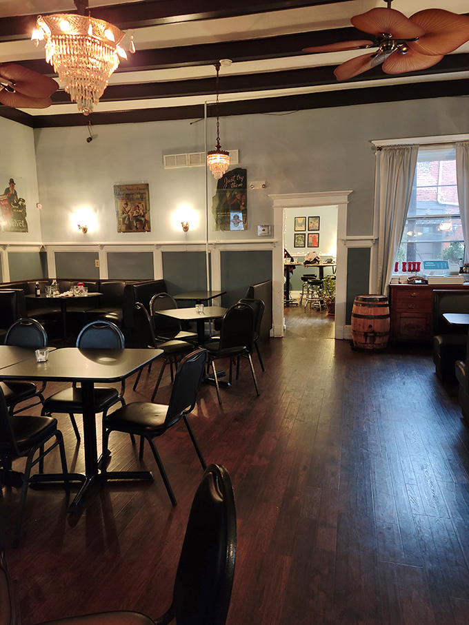 Crystal chandeliers meet casual dining tables in a space where vintage charm and comfortable seating create the perfect neighborhood gathering spot.