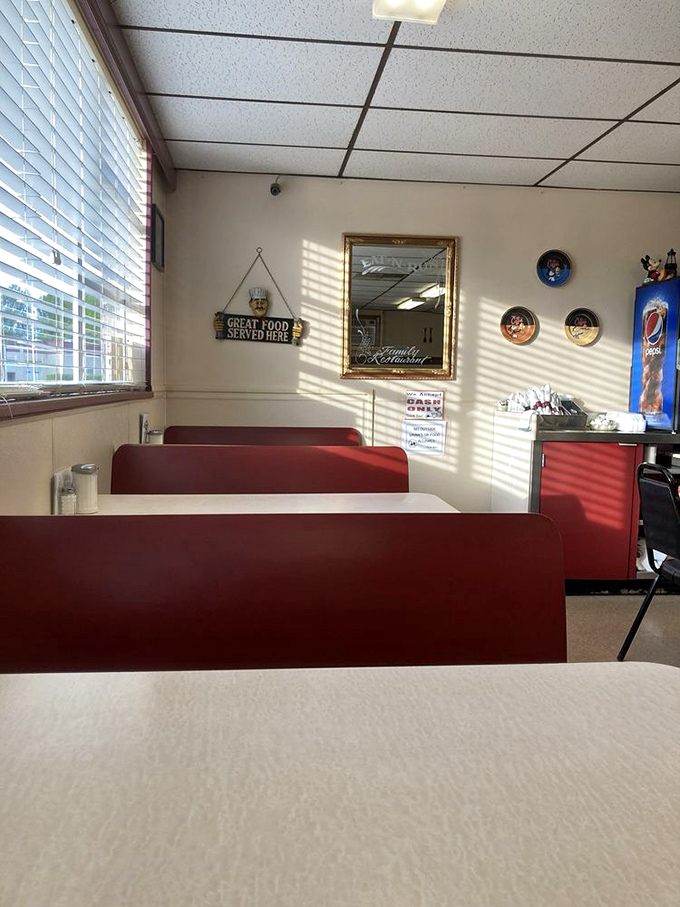 Red booths bathed in morning light, with a sign that simply states "Great Food Served Here." No false advertising detected in this establishment.