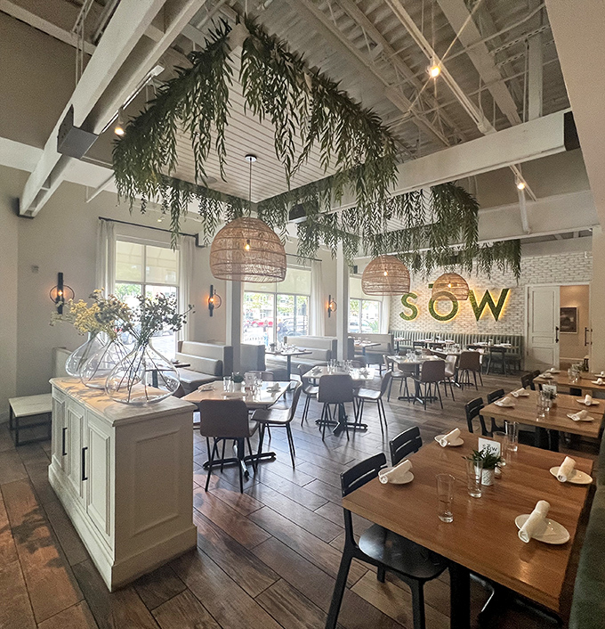 Exposed ceiling beams and hanging greenery transform dining into an unexpectedly enchanting garden experience.