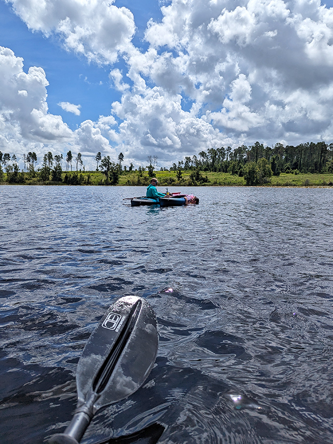 Paddle politics: the person in front controls direction, the one in back controls complaints. Lake Louisa's calm waters make for perfect kayaking diplomacy.