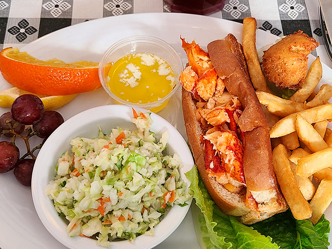 The lobster roll arrives like a celebrity—perfectly dressed, ready for its close-up, and surrounded by an entourage of fresh sides that complement without stealing the spotlight.