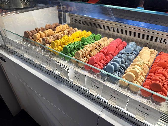 Macarons arranged with military precision, each one a perfect ambassador of flavor. Resistance is futile, just accept you'll be trying at least three.
