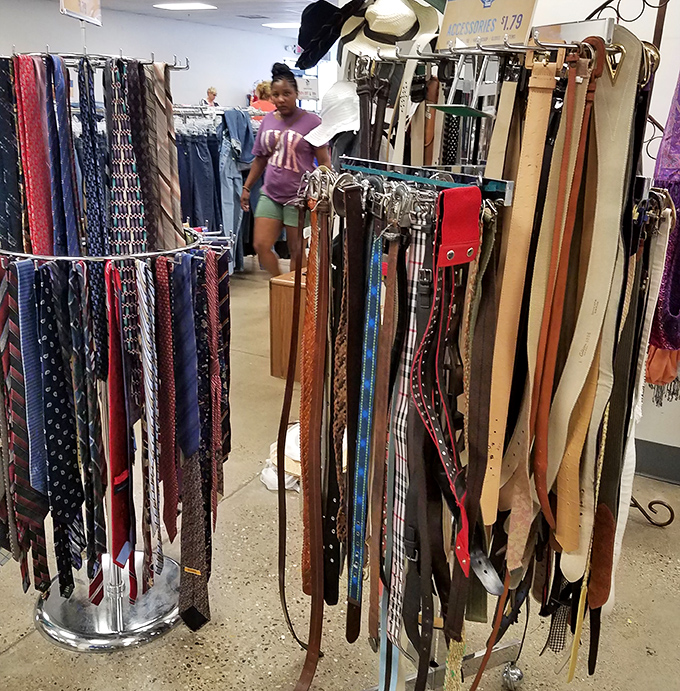 Neckties and belts hang like colorful stalactites in a cave of forgotten fashion. That paisley number? Pure '90s gold.