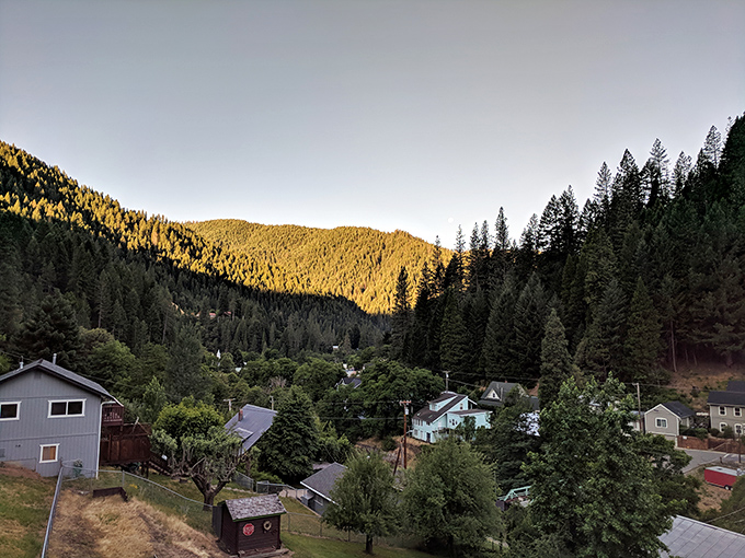 Homes tucked into the mountainside catch the golden hour light, reminding you that real estate value should sometimes be measured in views, not square footage.