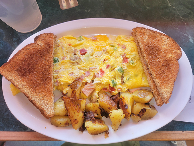 This omelet has more fillings than your average novel, flanked by toast soldiers standing at attention.