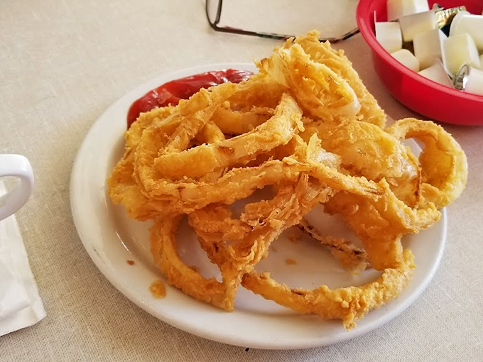 Onion rings so perfectly golden and crisp they deserve their own trophy. These aren't just sides—they're the main event that happens to share a plate.