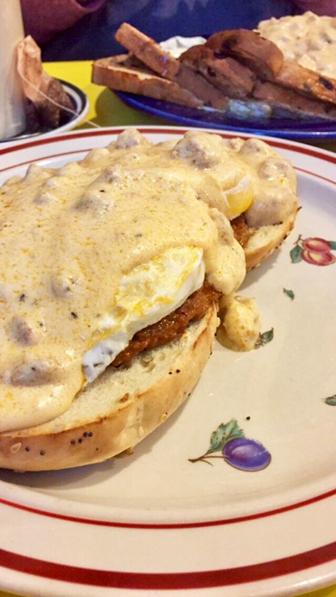 Breakfast engineering at its finest. Eggs, scallions, and gravy atop a golden waffle&mdash;it's like someone built a delicious breakfast skyscraper.