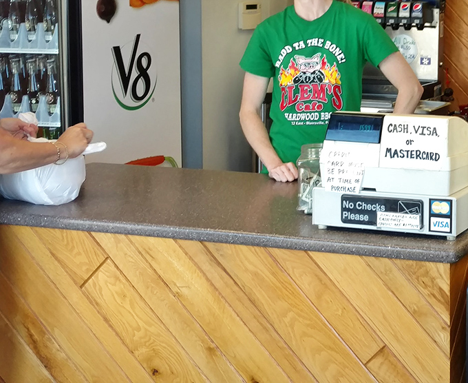 The ordering counter&mdash;where barbecue dreams begin their journey to reality. That "Good to the Bone" shirt speaks the absolute truth.