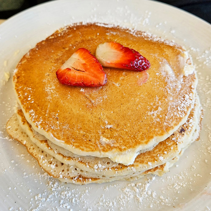 Pancakes stacked with military precision, dusted with powdered sugar and crowned with strawberries&mdash;breakfast royalty that demands your respect and your appetite.