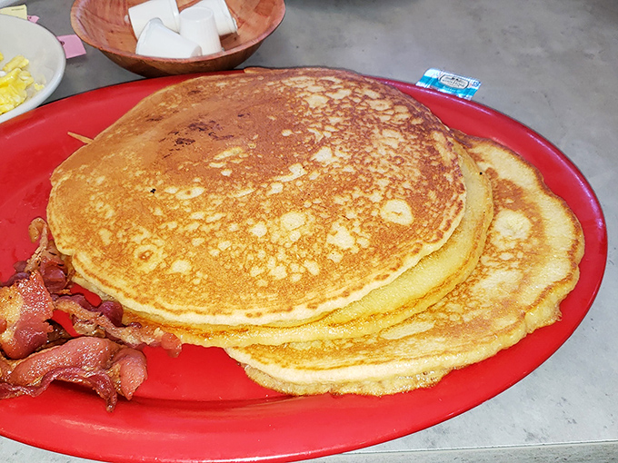 Golden pancakes stacked high with a side of bacon&mdash;the breakfast that says, "Today might be tough, but at least it started right."