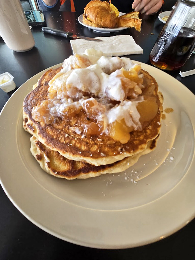 These pancakes aren't just breakfast, they're an engineering marvel&mdash;fluffy enough to float yet substantial enough to support that glorious crown of apples and cream.