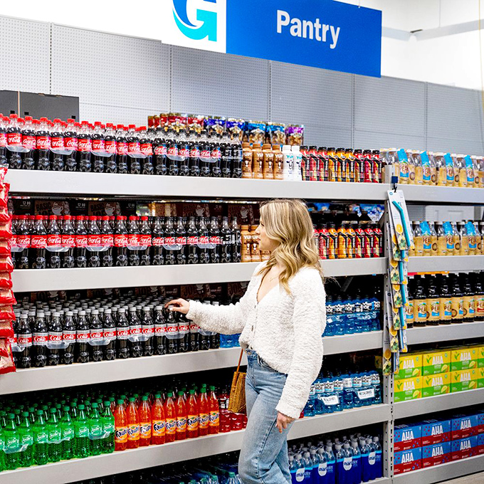 The pantry section offers everything from Coca-Cola to snacks, because bargain hunters need proper hydration for marathon shopping sessions.