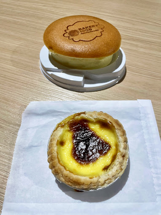 A custard tart that would make Portuguese pastry chefs nod in approval, paired with what appears to be a signature branded pancake.