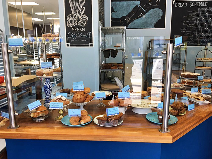 Where pastries meet their adoring public. The glass barrier exists only to prevent impulsive face-planting into the display.