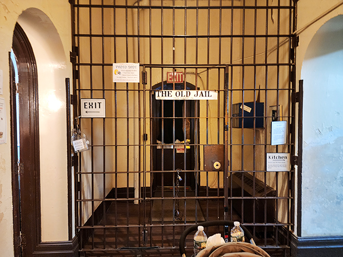 "The Old Jail" sign behind bars creates the perfect photo opportunity for visitors, though thankfully you get to leave after the tour.