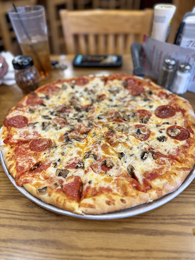 This pizza showcases the perfect marriage of crispy crust, melted cheese, and generous pepperoni coverage.