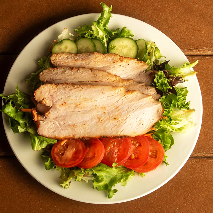 Even the salads get the smoke treatment here. Sliced smoked turkey breast atop fresh greens proves barbecue joints can do more than just meat and fire.