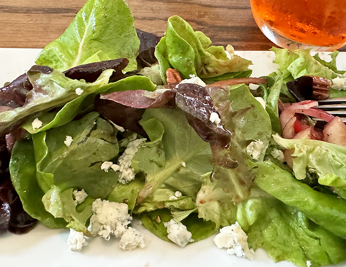 Even the salads deserve attention &ndash; fresh greens, crumbled cheese, and a light dressing create the perfect opening act before the main pizza event.