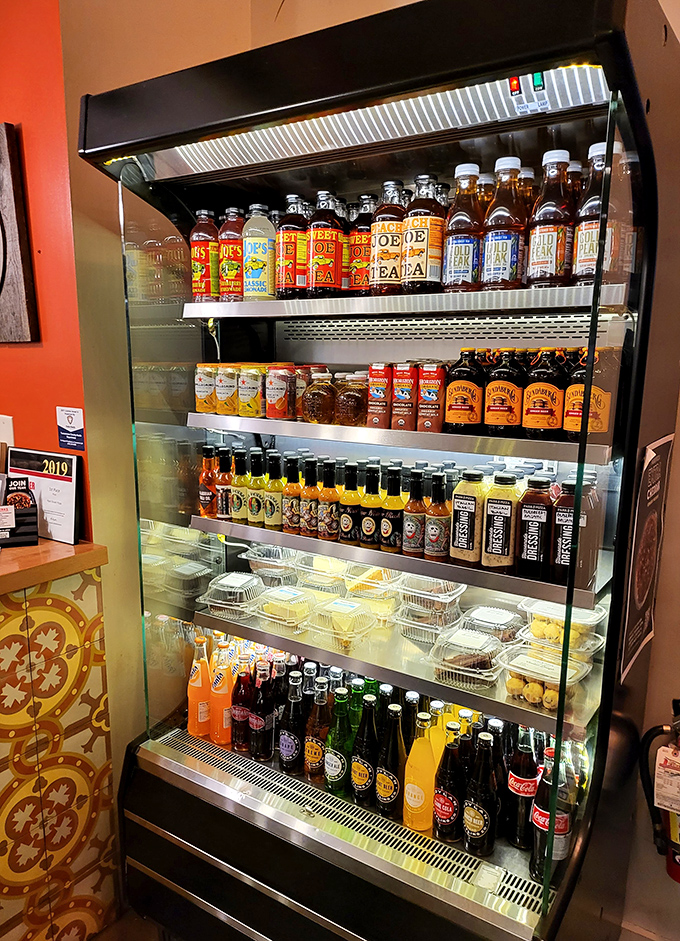 The beverage case isn't just stocked—it's curated, with craft sodas and local brews that elevate the entire pizza experience.