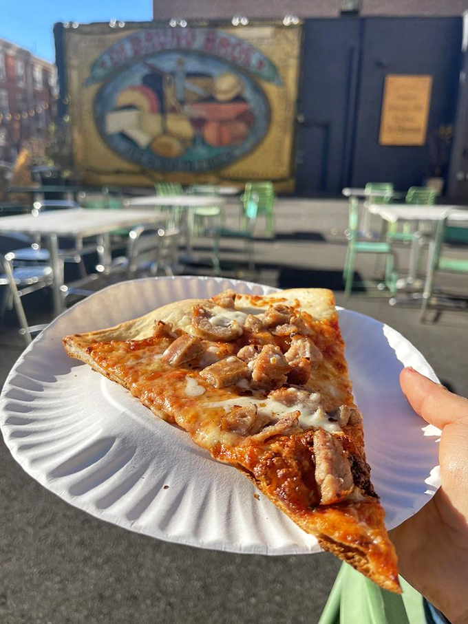 This sausage pizza slice doesn't just satisfy hunger—it abolishes it with extreme prejudice and exceptional flavor.