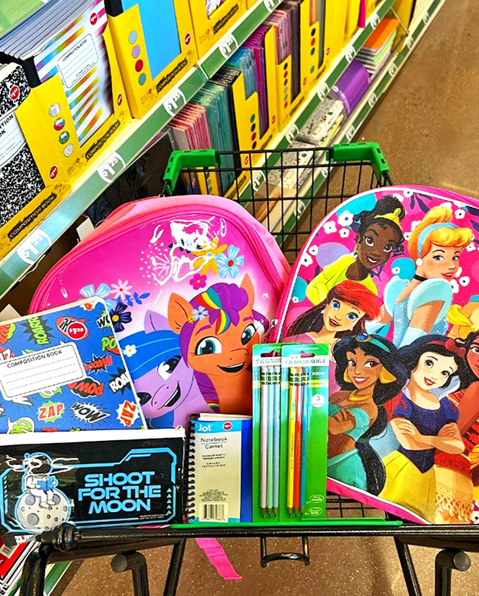 Back-to-school shopping cart filled with colorful supplies &ndash; childhood excitement and parental budget relief coexisting in perfect harmony.