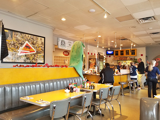 The dining room's retro charm, complete with that signature pickle mascot, creates an atmosphere where calories simply don't count and diet plans go to die.