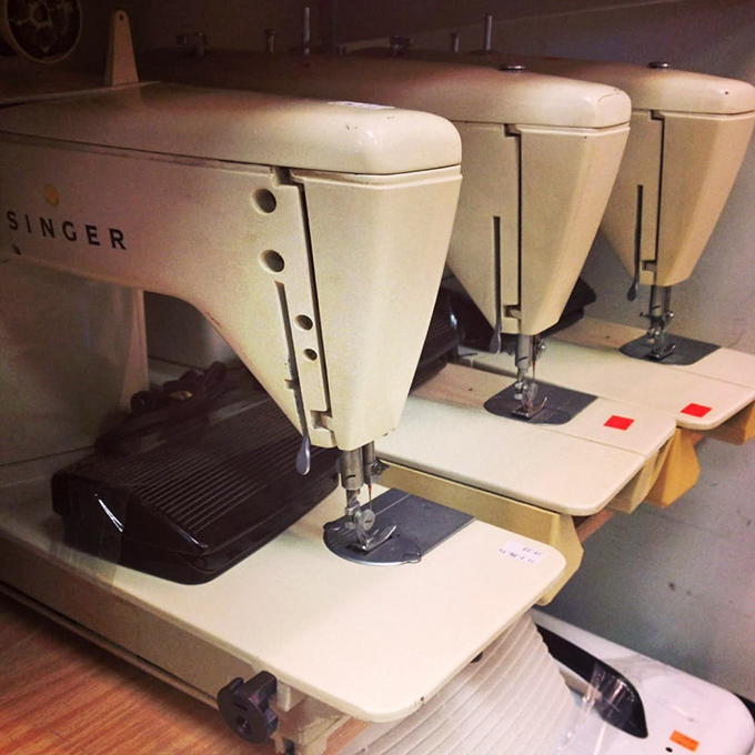 Vintage Singer sewing machines stand at attention like soldiers from a more durable era. They don't make 'em like this anymore!