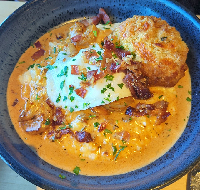 Shrimp and grits with a biscuit island rising from creamy depths. Southern comfort reimagined with the kind of sauce you'll be tempted to drink directly from the bowl.