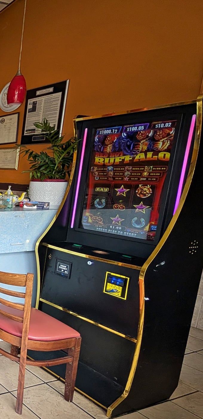 Between bites of curry, some patrons try their luck at the gaming machine &ndash; though the real jackpot is already on your plate.