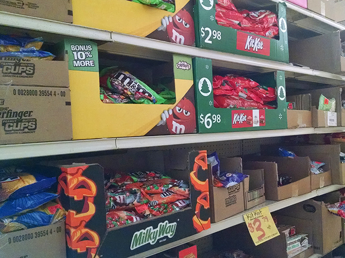 Holiday candy boxes stacked like sweet treasure chests. M&Ms, KitKats, and Milky Ways at prices that won't scare your wallet.