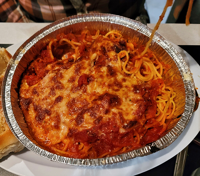 Spaghetti under a blanket of melted cheese &ndash; because sometimes more really is more, folks.