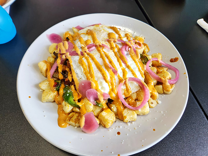 A mountain of home fries topped with cheese sauce and pickled onions&mdash;because potatoes deserve to dress up fancy sometimes too.