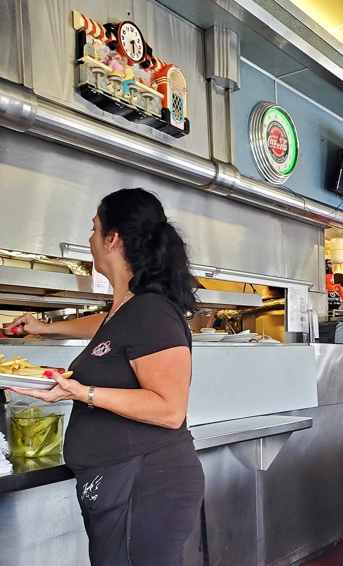 The kitchen pass-through window offers a glimpse into the choreographed dance that brings your breakfast dreams to life.