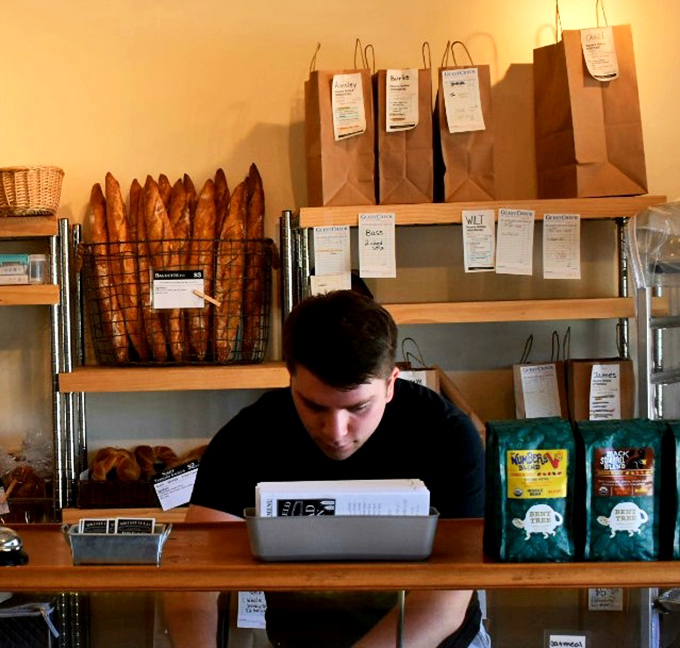 Behind every great bakery is a team of dedicated bread wizards. Those baguettes standing at attention in the background are ready for their forever homes.