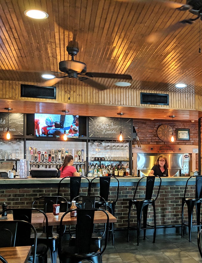 Warm wood ceilings, exposed brick, and a well-stocked bar create the trifecta of comfort that makes leaving harder than deciding what to order.