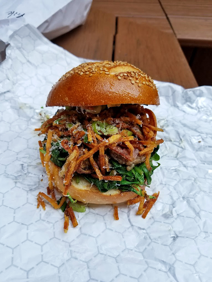 The burger that launched a thousand road trips. That glistening sesame bun cradling layers of savory goodness proves simplicity is the ultimate sophistication.