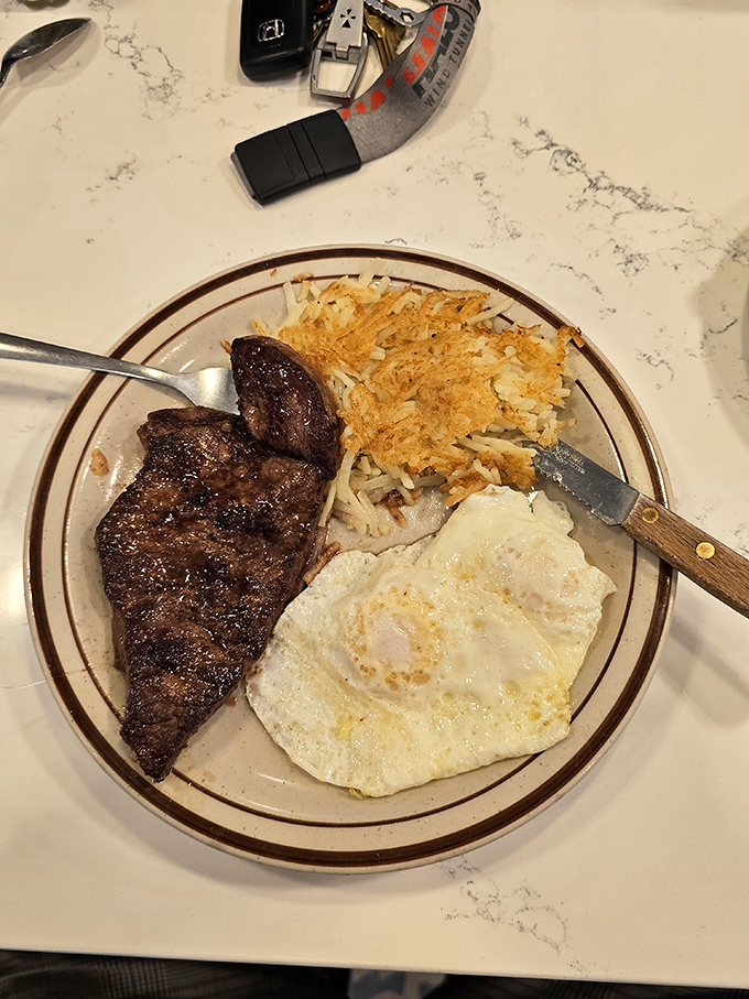 The classic American breakfast trifecta: steak, eggs, and hash browns. When your plate looks like this, you know you're not in some pretentious bistro.