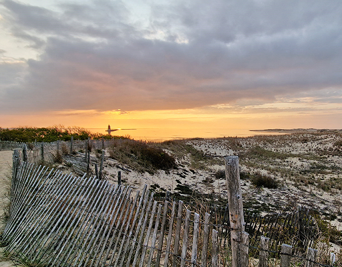 Sunset transforms the dunes into a golden kingdom. Those wooden fences aren't just for erosion control&mdash;they're front-row seats to nature's light show.