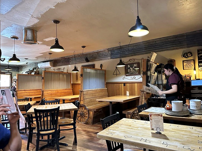 The dining room's corrugated metal accents and pendant lighting create that perfect "rustic chic" atmosphere Instagram filters try to replicate.