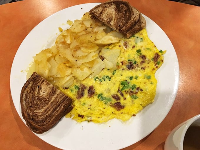 An omelet that's seen the inside of a vegetable drawer and lived to tell about it, flanked by home fries and marble rye toast.