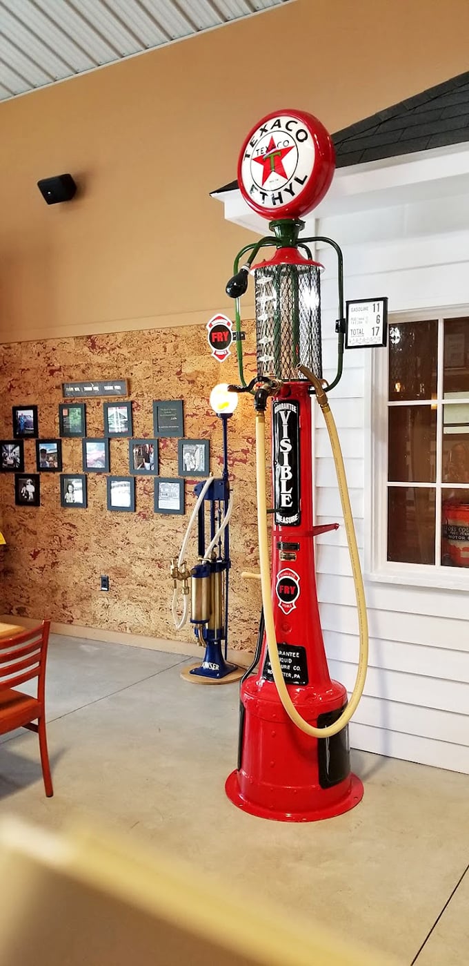 The Texaco Fire Chief pump stands ready for service, its vibrant red and gleaming chrome recalling days when gas jockeys wore uniforms and cleaned windshields.