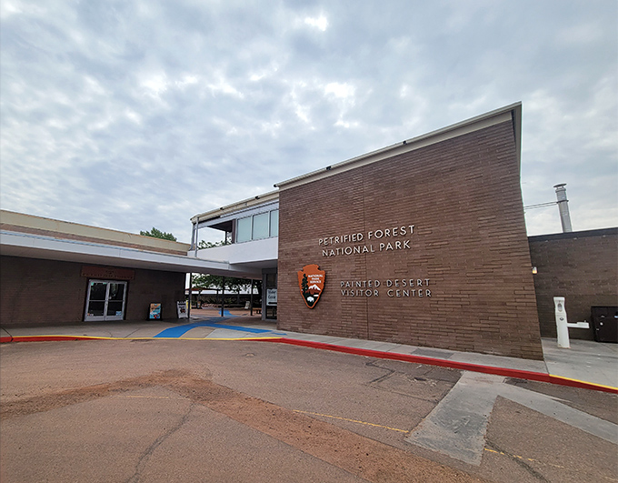 Mid-century modern meets ancient wonder. The visitor center's clean lines and brick facade serve as your gateway to geological chaos just beyond. 