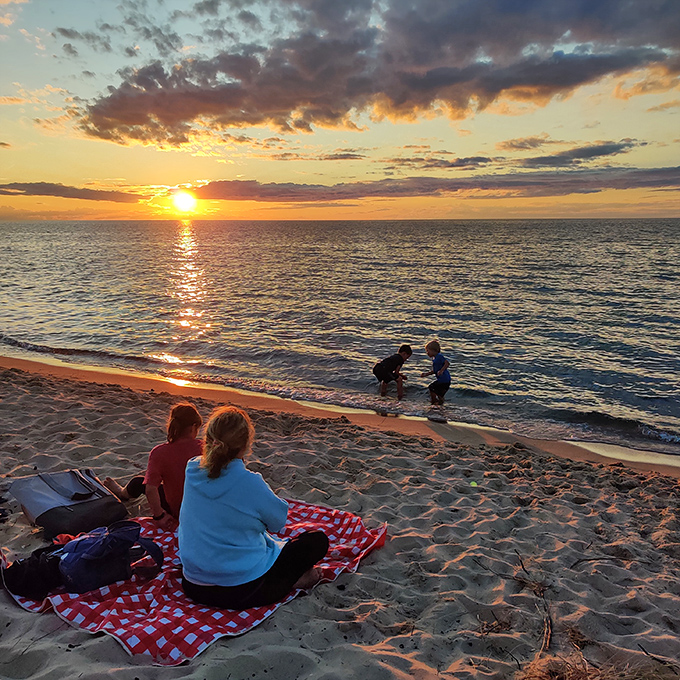 Sunset transforms ordinary moments into magic, as families create memories that will outlast footprints in the sand.
