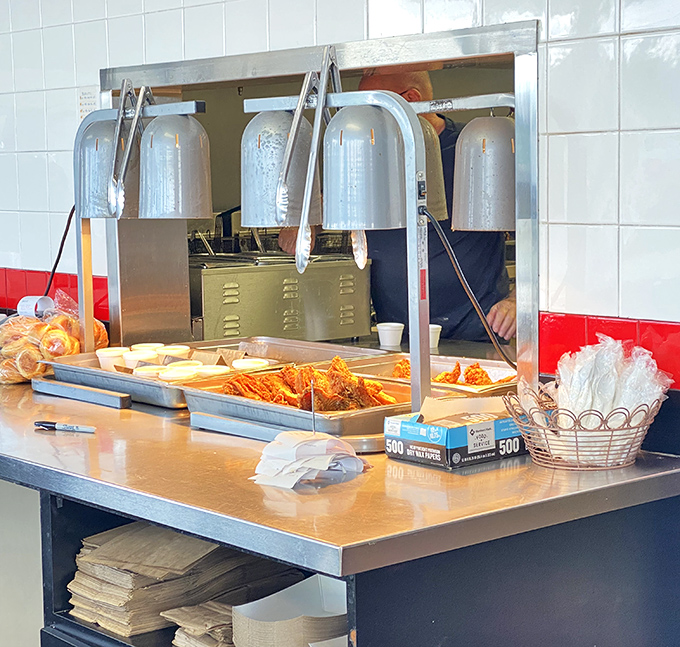 Behind this window, culinary magic happens with the kind of straightforward efficiency that makes you realize why some restaurants survive while trends fade away.