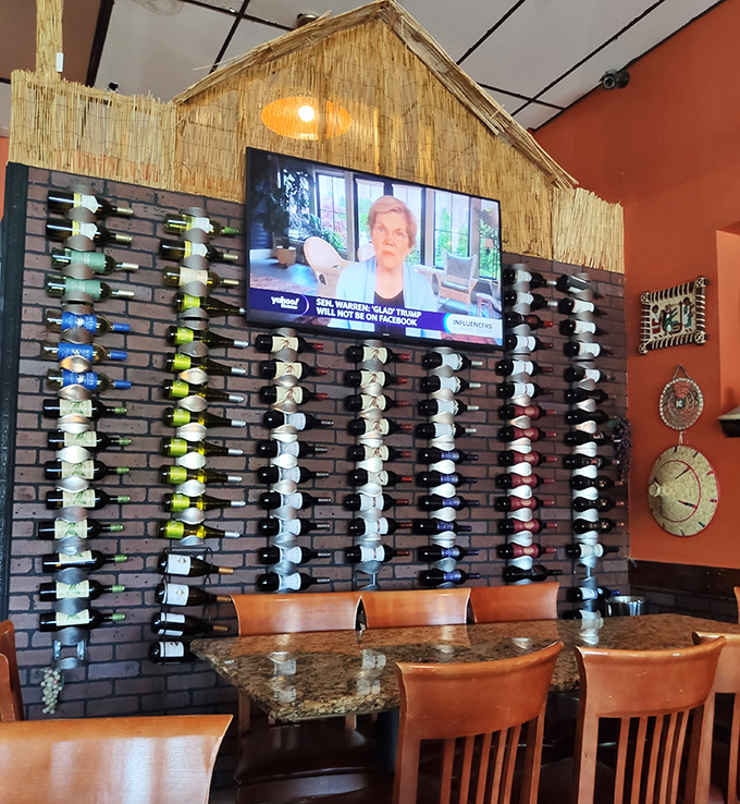 That impressive wall of wine bottles isn't just decoration&mdash;it's a liquid library of possibilities. The thatched roof above adds authentic charm to modern libations.
